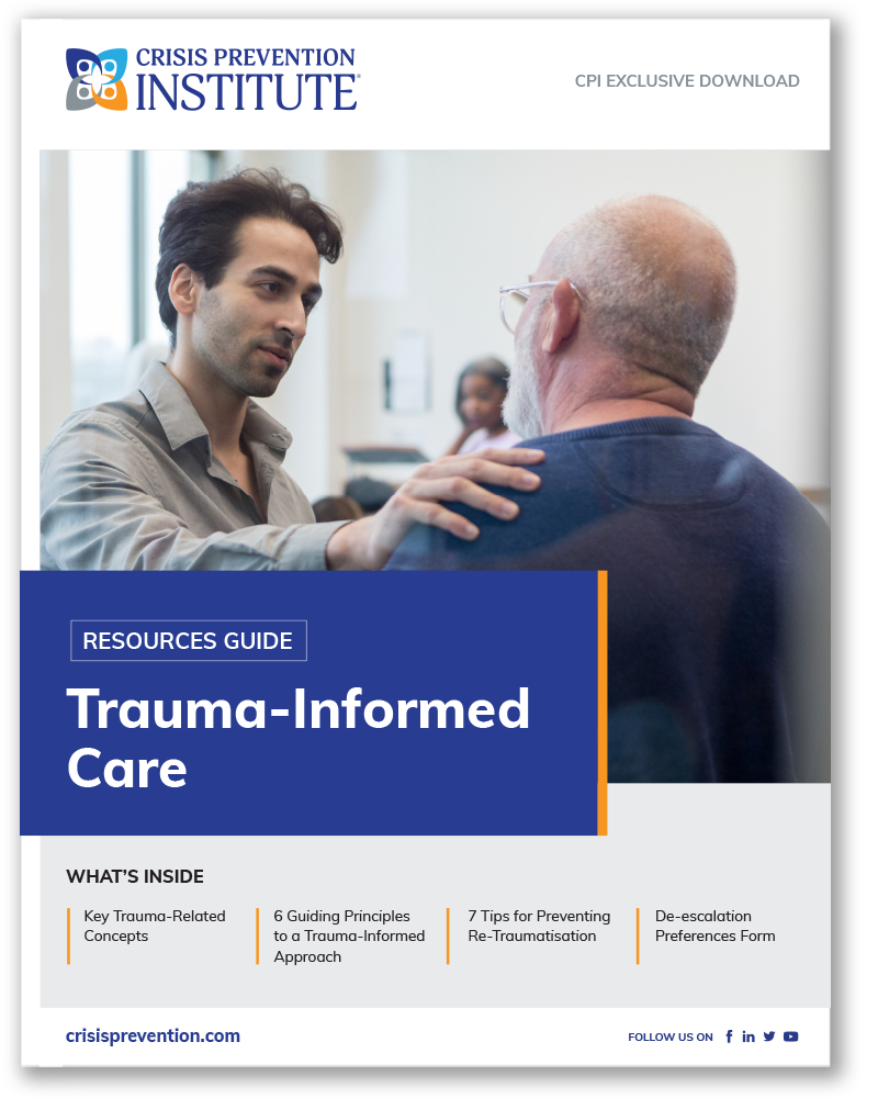 In an office, one man is talking to another, both focused on their ...